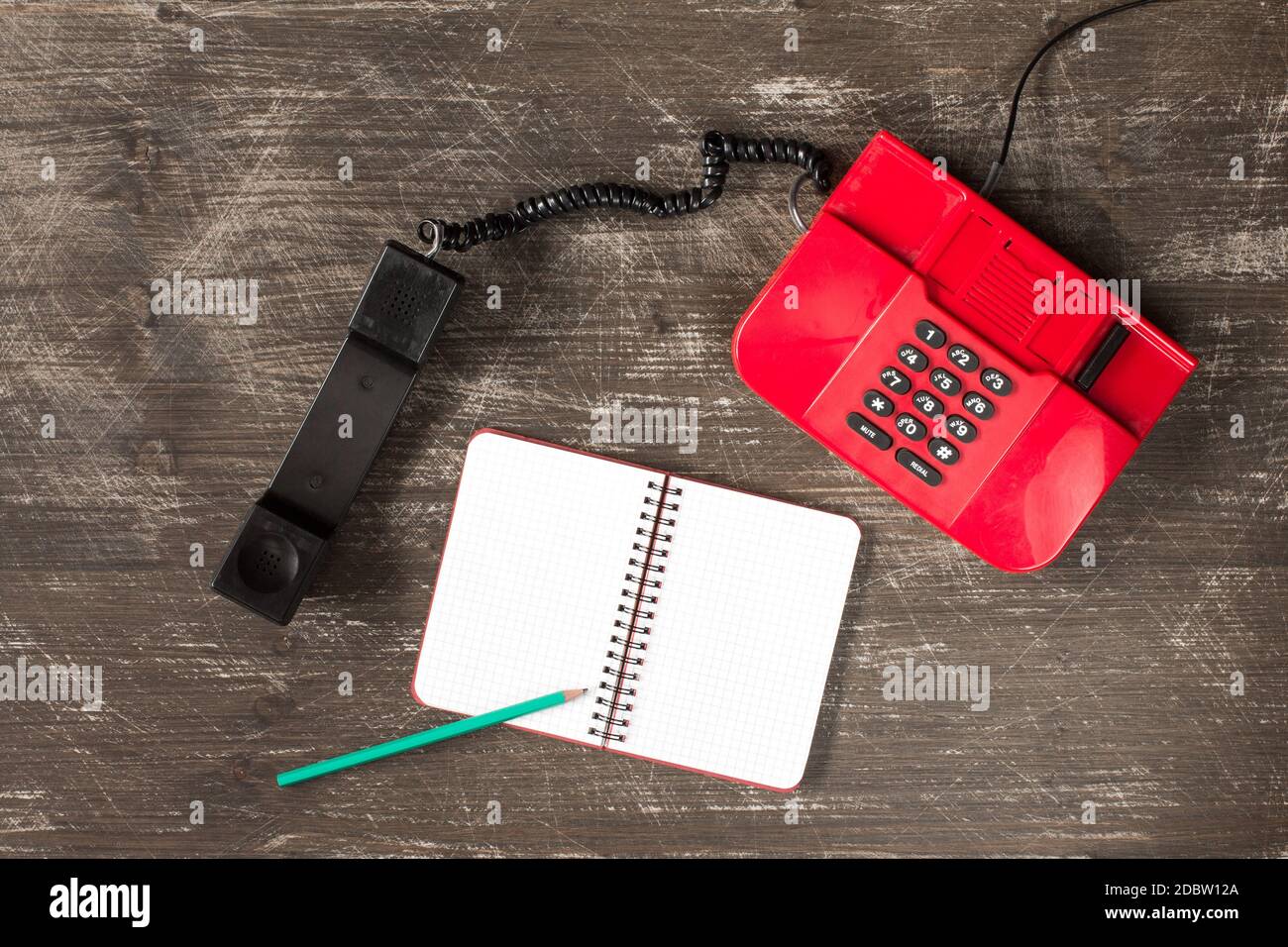 Old telephone and blank notebook on wooden table. Top view Stock Photo ...