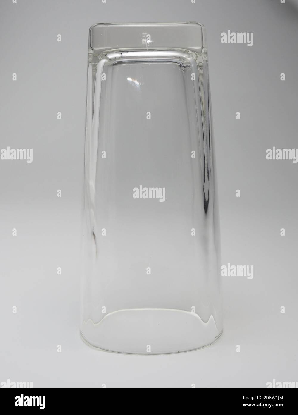 Empty glass Upside down on a white background Stock Photo - Alamy