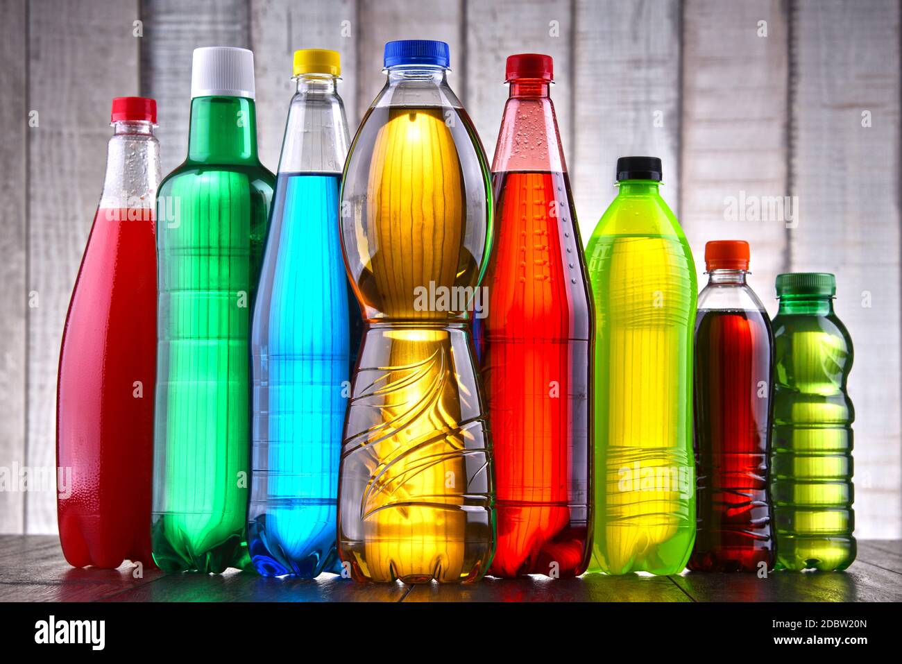 Plastic bottles of assorted carbonated soft drinks in variety of colors ...