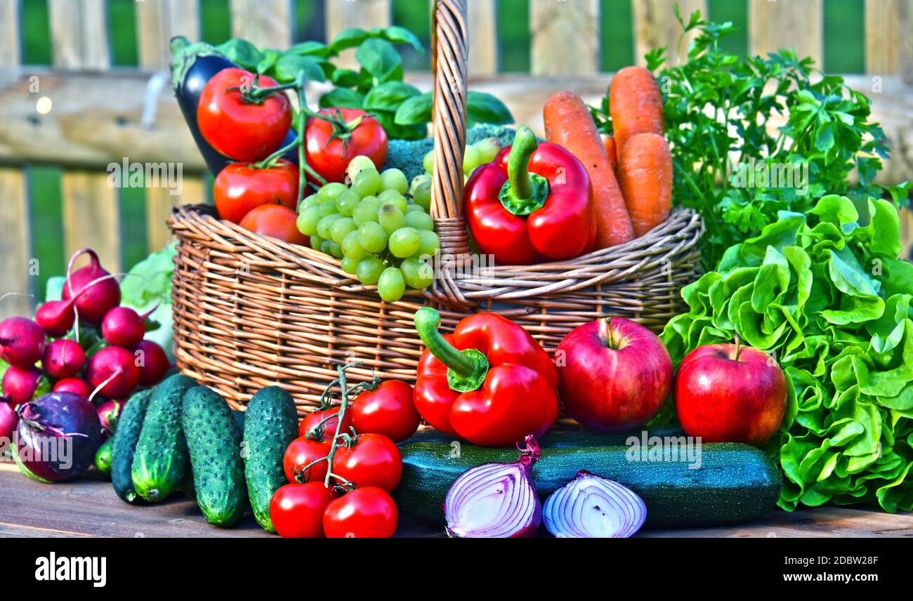 Variety of fresh organic vegetables in wicker basket Stock Photo - Alamy