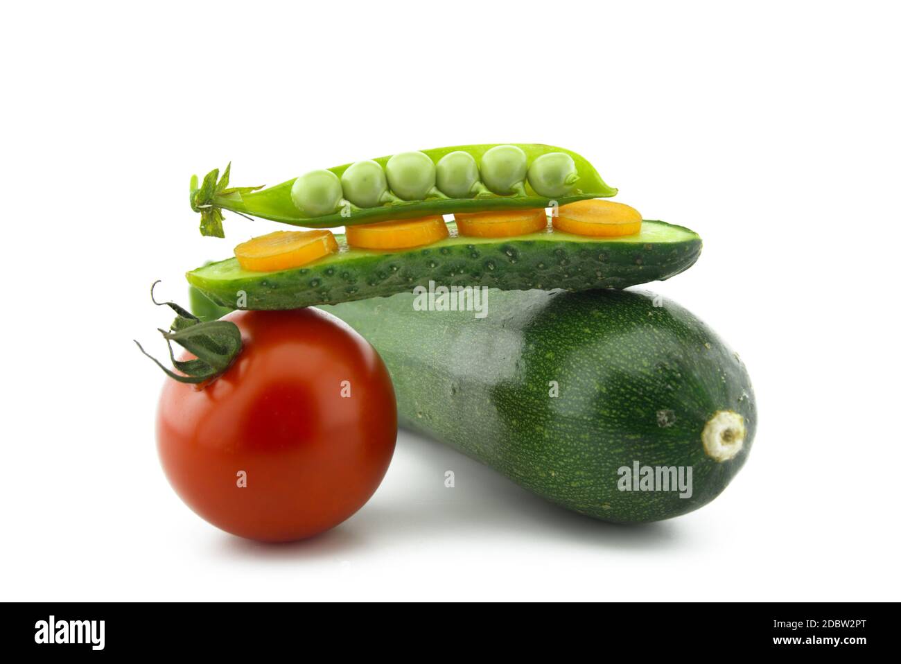 Healthy fresh vegetable still life over white with ripe red tomatoes ...