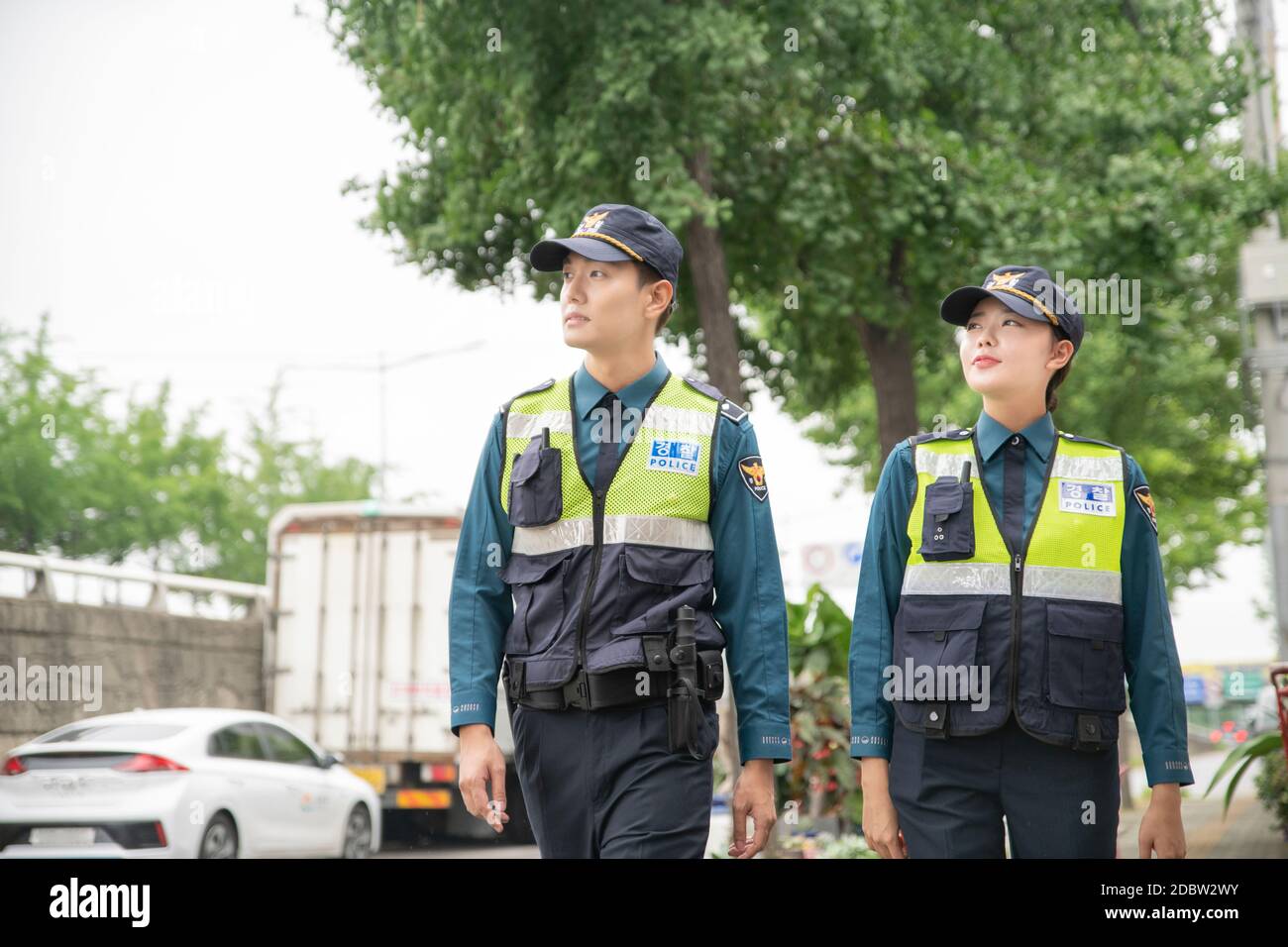 Asian male and female two police officers 113 Stock Photo - Alamy