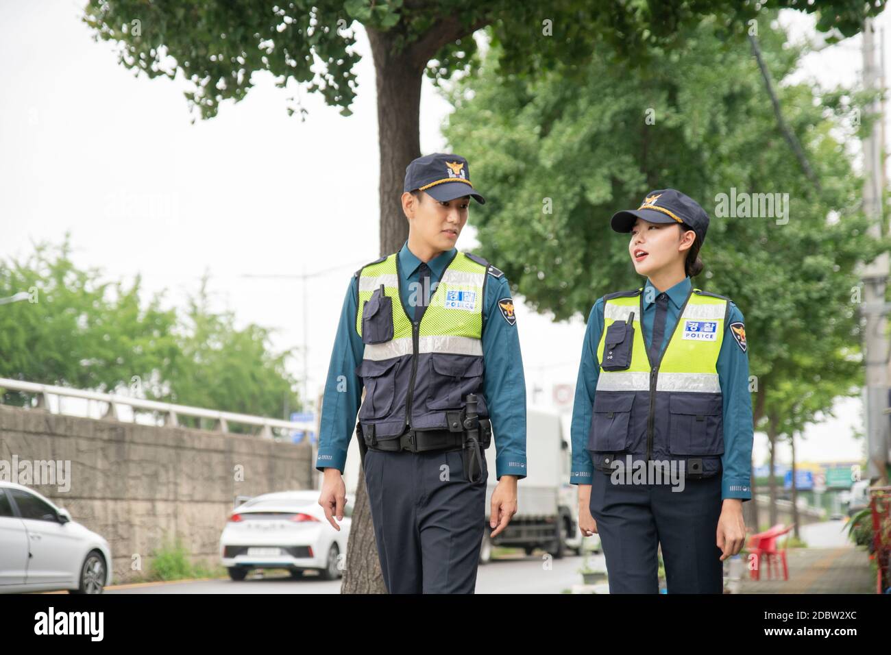 Asian male and female two police officers 114 Stock Photo - Alamy