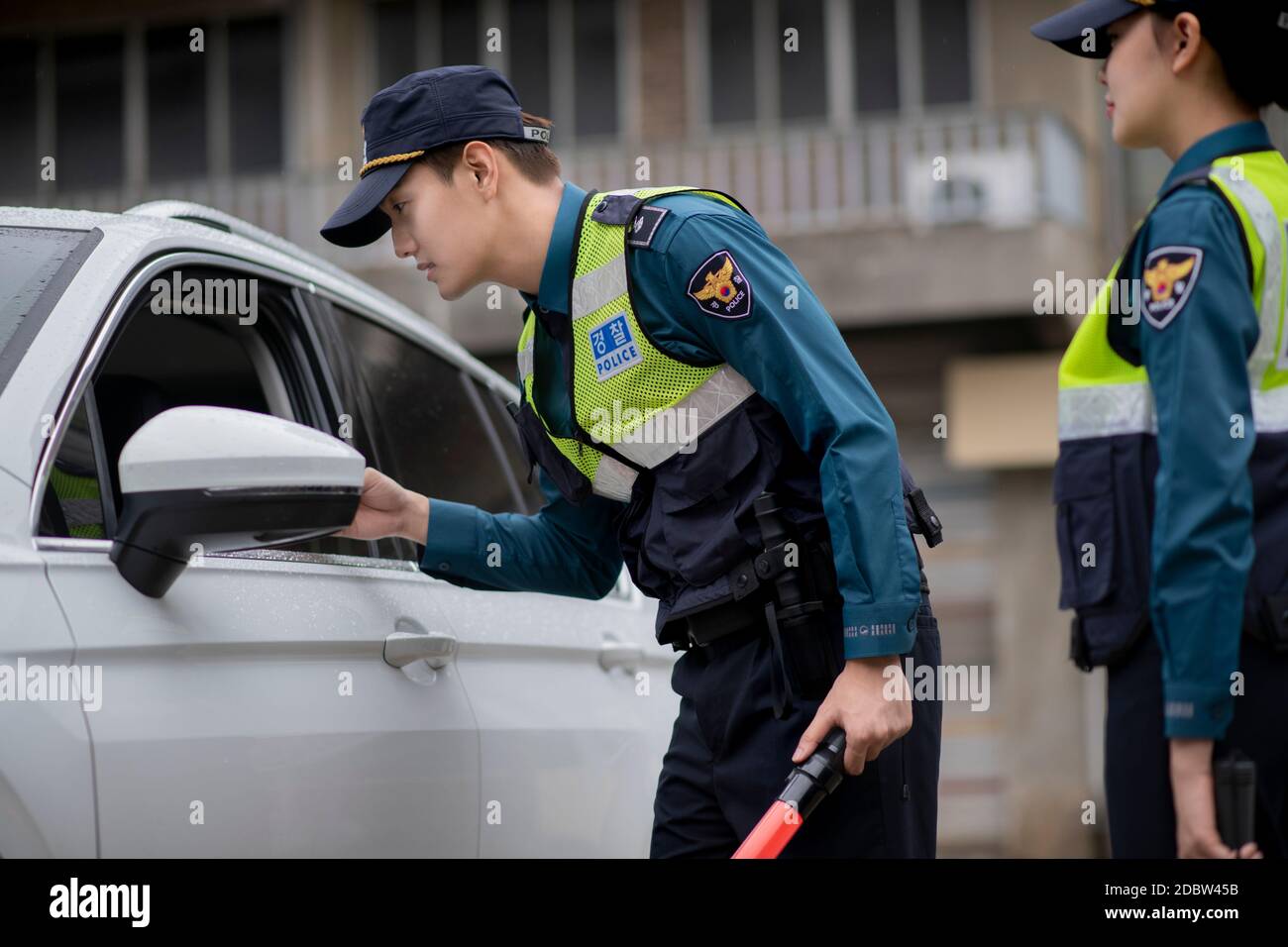 Asian male and female two police officers 124 Stock Photo - Alamy