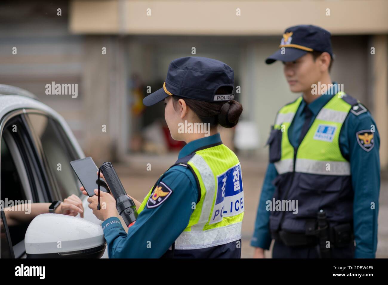 Two young talking to policeman hi-res stock photography and images - Alamy