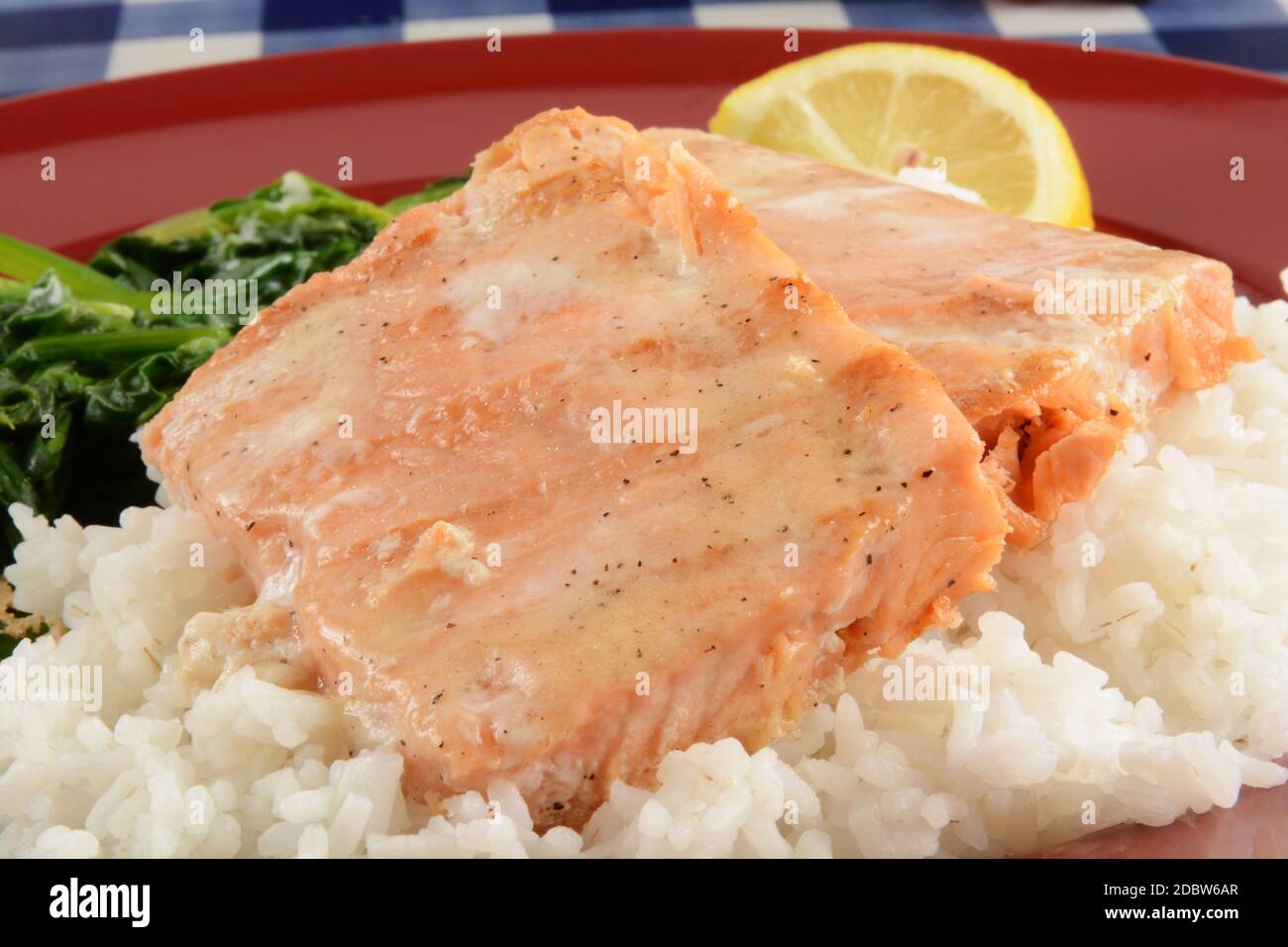 Grilled salmon steaks served on a bed of rice with spinach Stock Photo ...