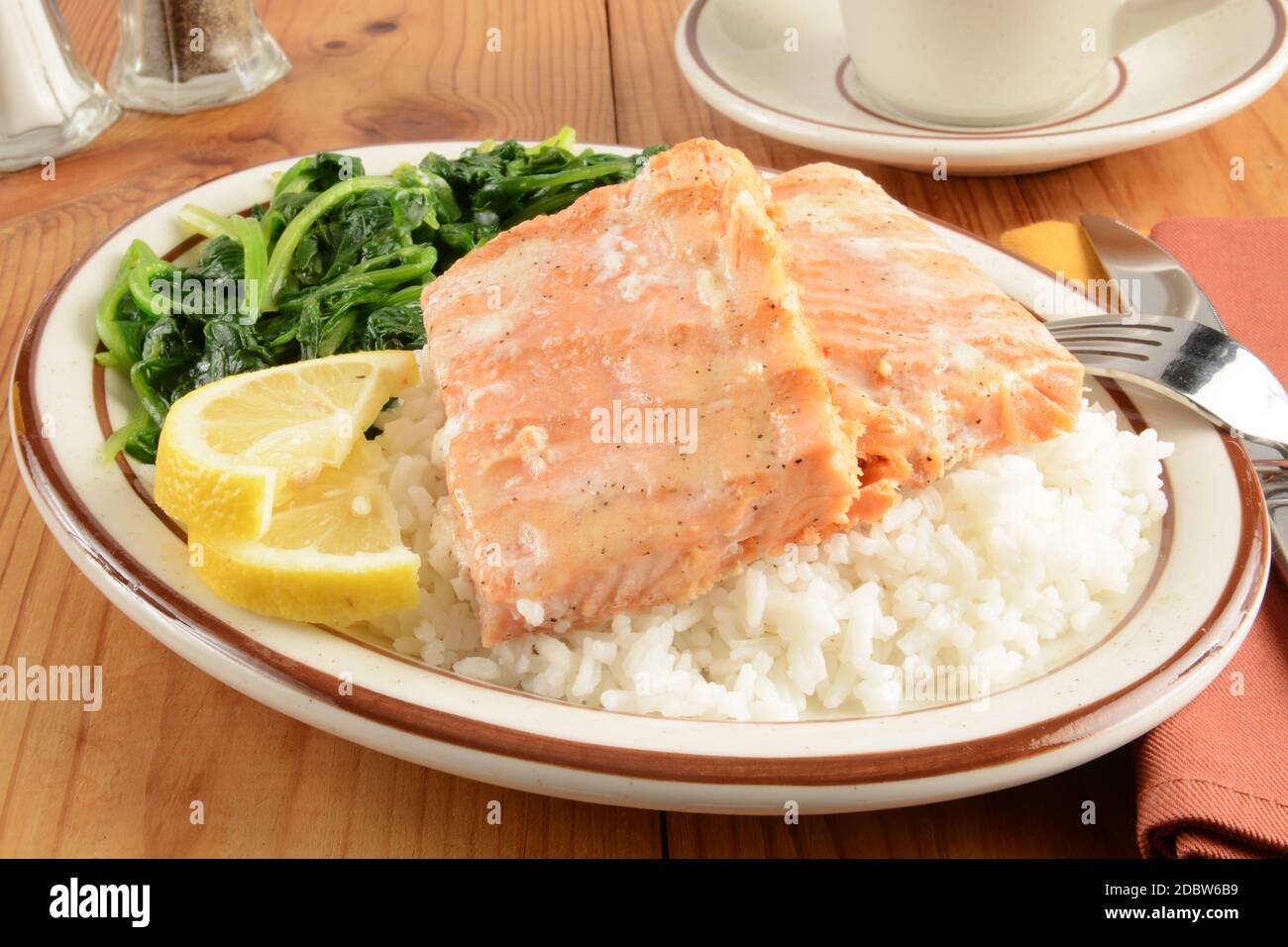 Grilled salmon steaks on a bed of steamed rice with spinach Stock Photo ...