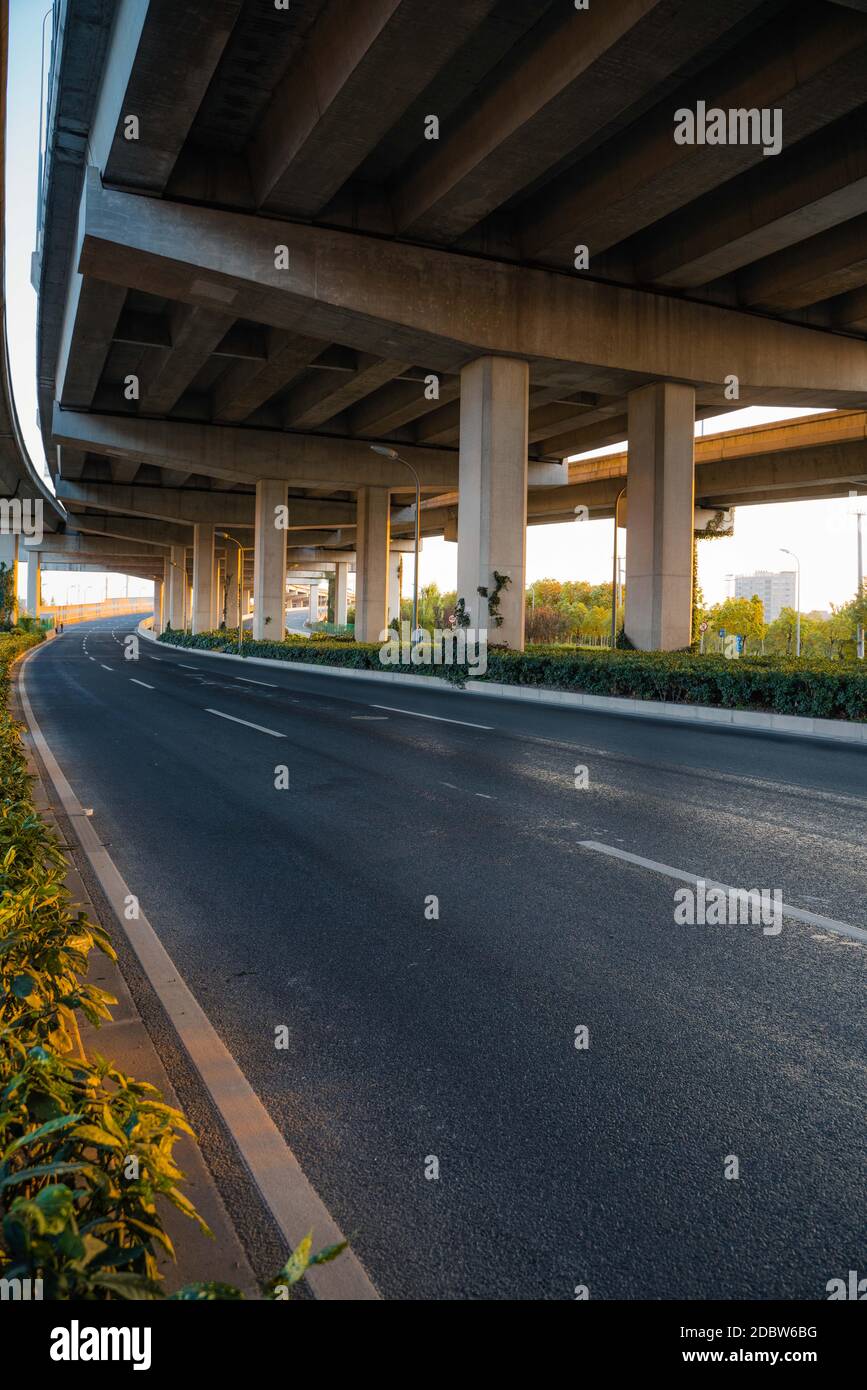 Urban road under overpass bridge Stock Photo - Alamy