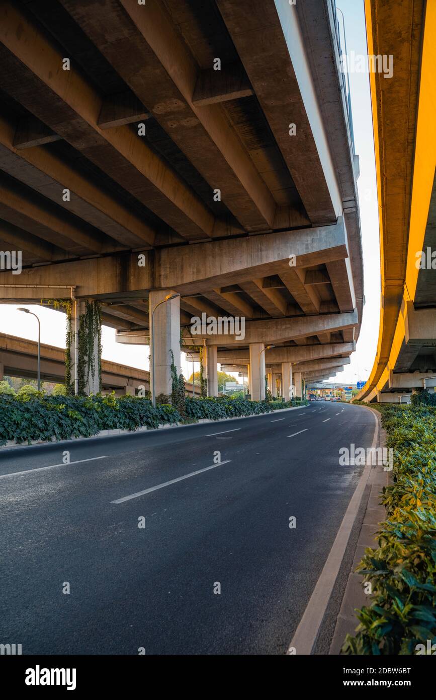 Urban road under overpass bridge Stock Photo - Alamy