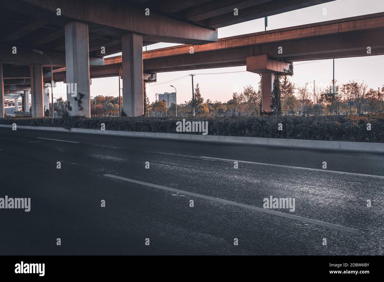 Urban road under overpass bridge Stock Photo - Alamy