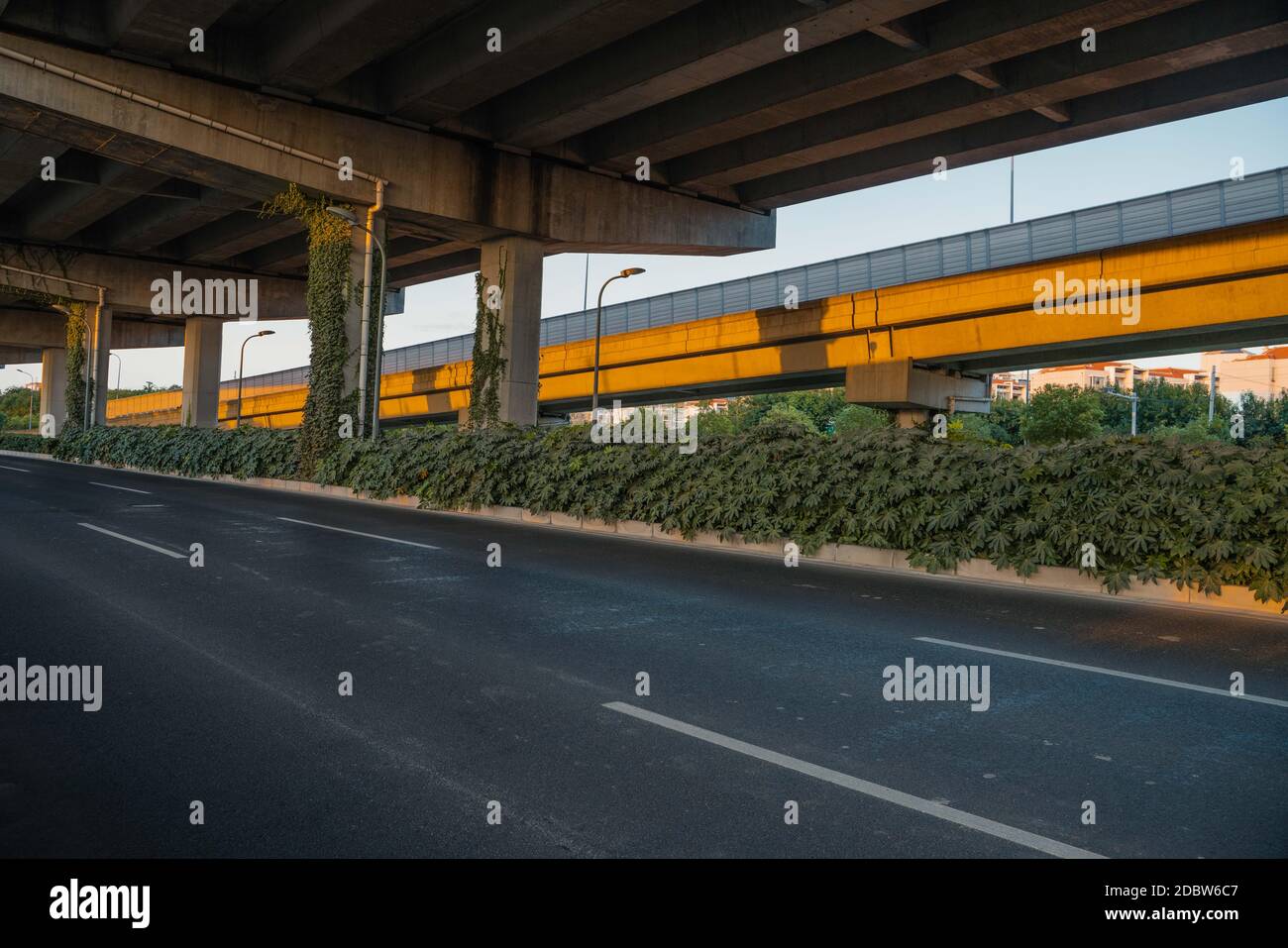 Urban road under overpass bridge Stock Photo - Alamy