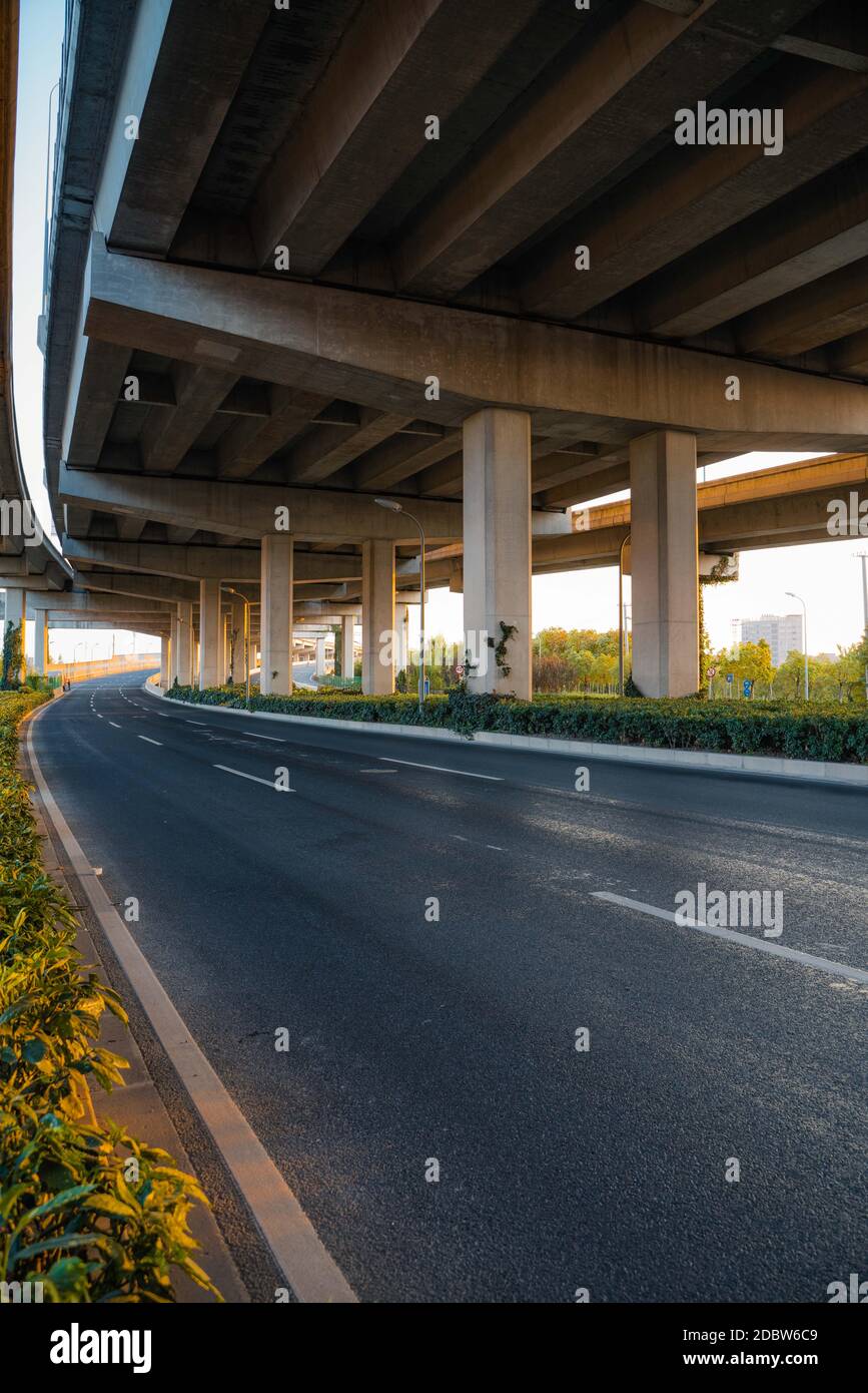 Urban road under overpass bridge Stock Photo - Alamy