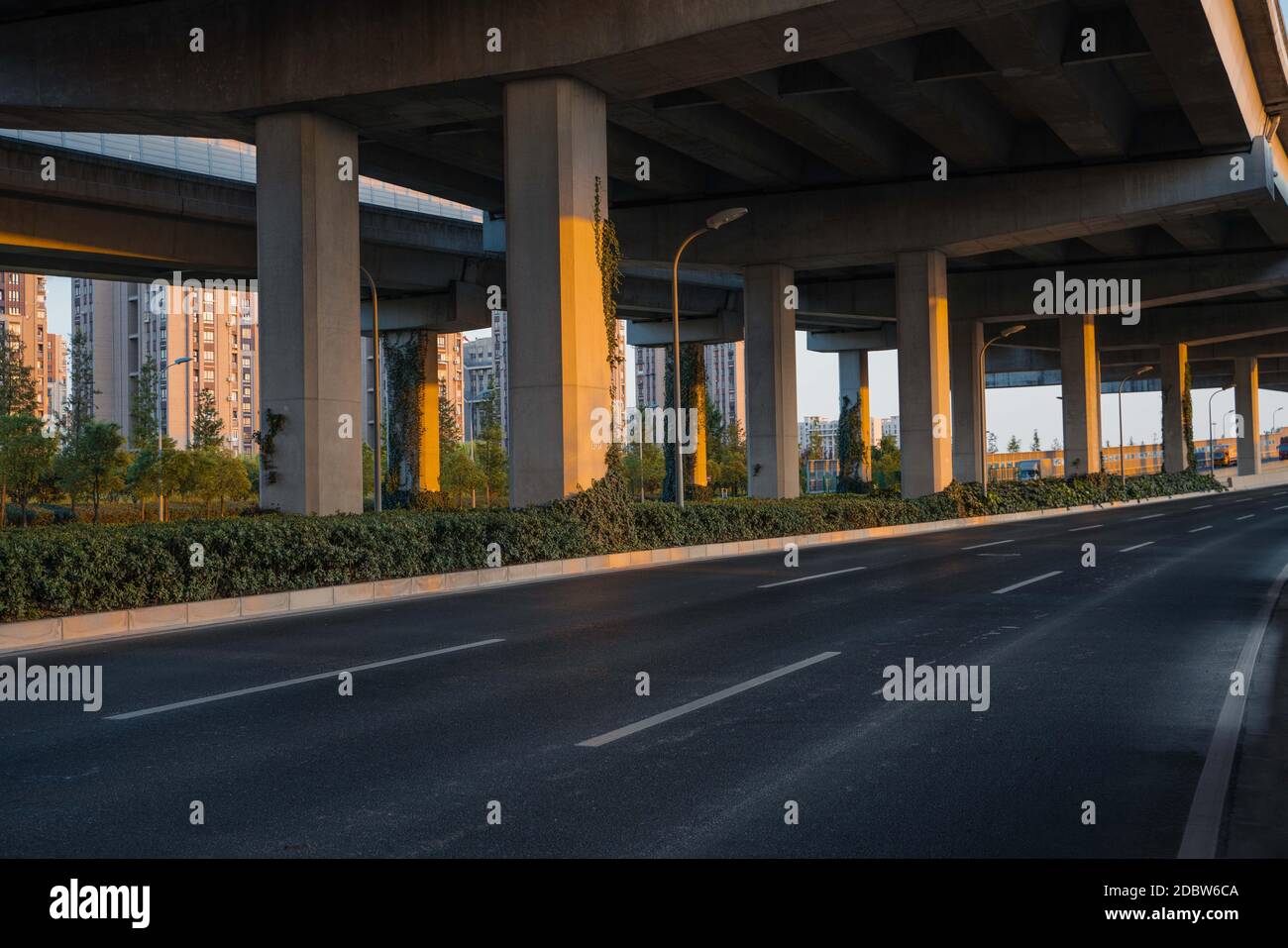 Urban road under overpass bridge Stock Photo - Alamy