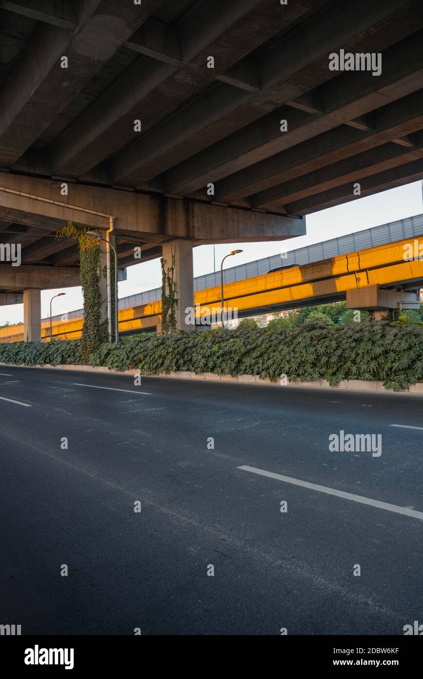 Urban road under overpass bridge Stock Photo - Alamy