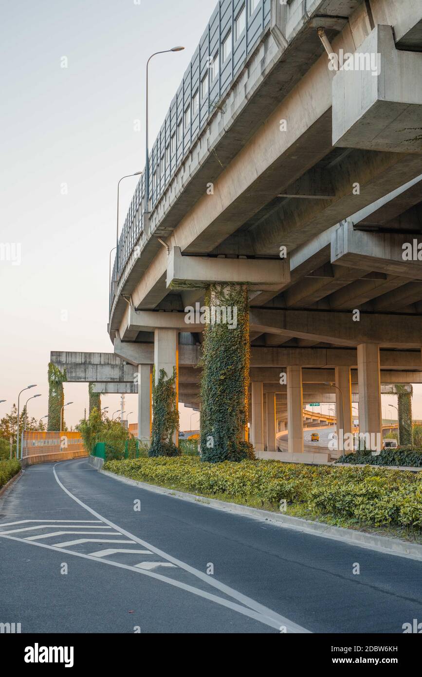 Urban road under overpass bridge Stock Photo - Alamy