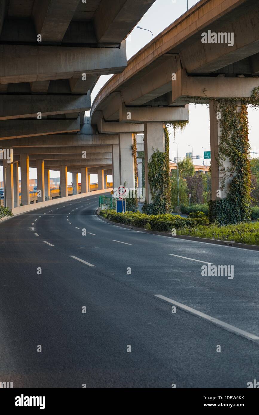 Urban road under overpass bridge Stock Photo - Alamy