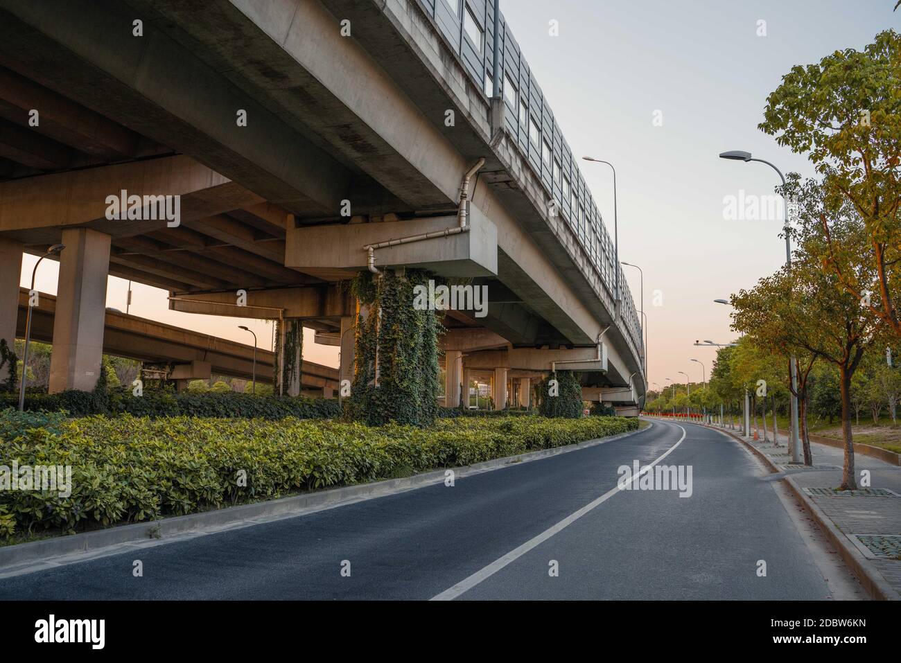 Urban road under overpass bridge Stock Photo - Alamy