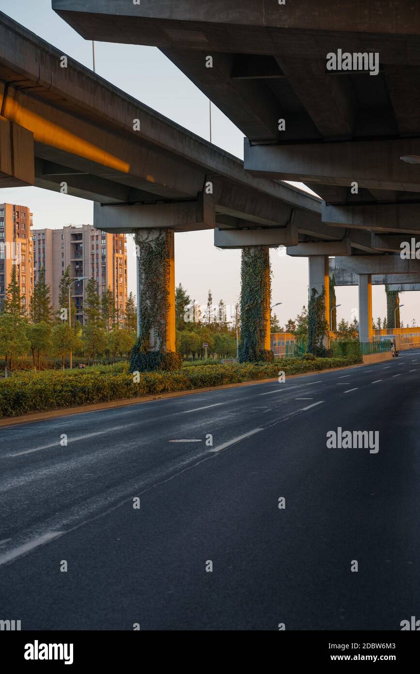 Urban road under overpass bridge Stock Photo - Alamy