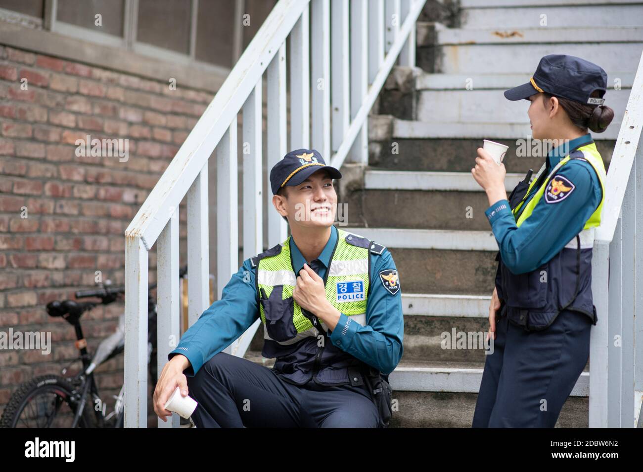 Two young talking to policeman hi-res stock photography and images - Alamy