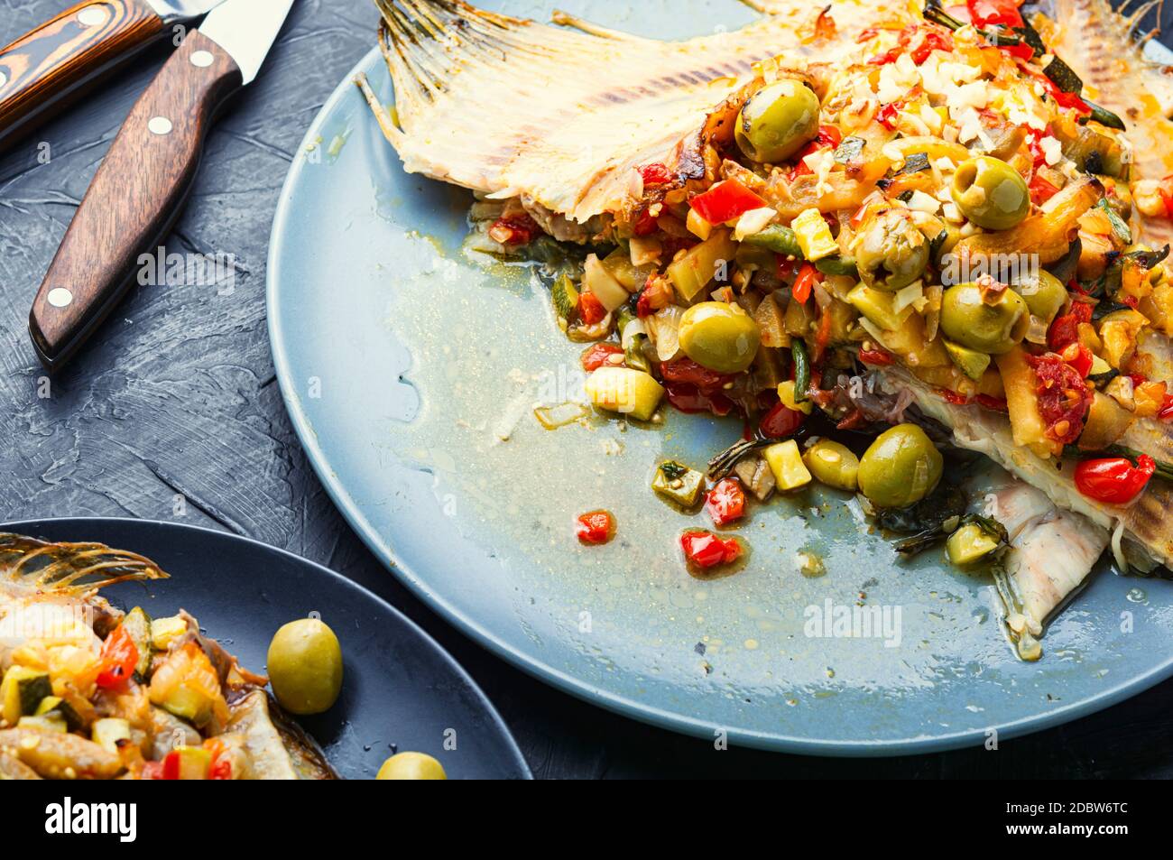 Plaice flounder or flat-fish baked with vegetables. Fried fish with ...