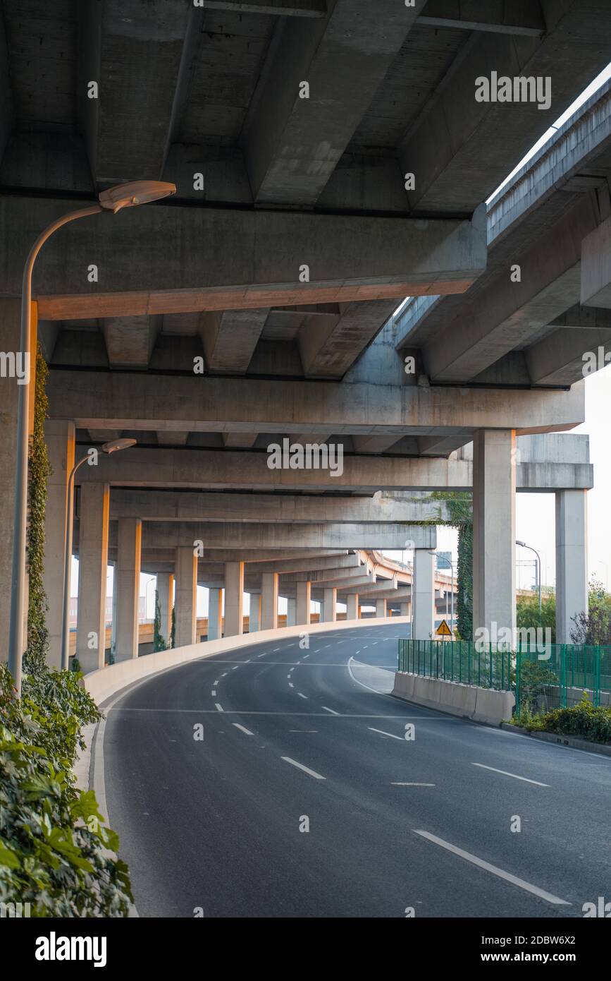 Urban road under overpass bridge Stock Photo - Alamy