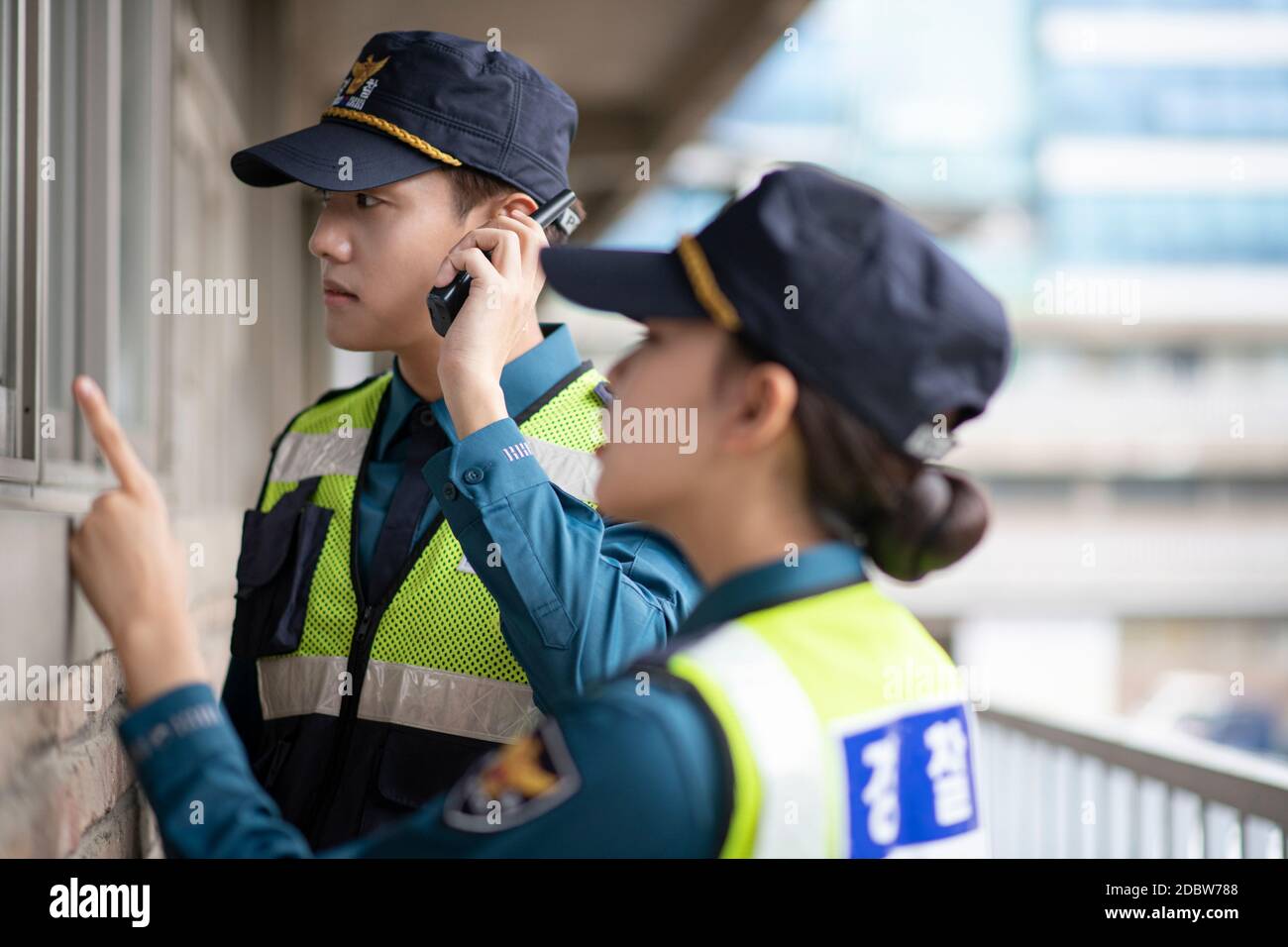 Asian male and female two police officers 146 Stock Photo - Alamy