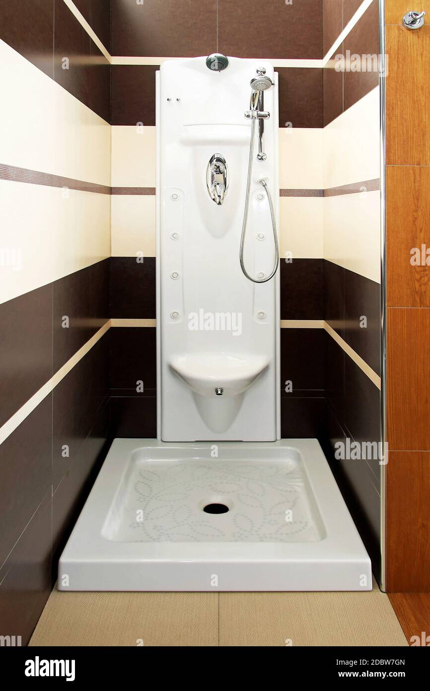 Inside of square shower with brown tiles Stock Photo - Alamy