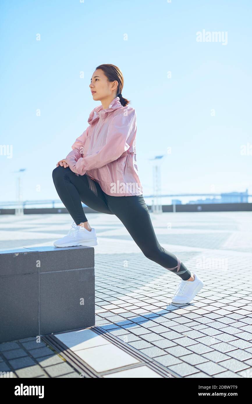 Young Japanese Woman Stretching Downtown Tokyo, Japan Stock Photo - Alamy