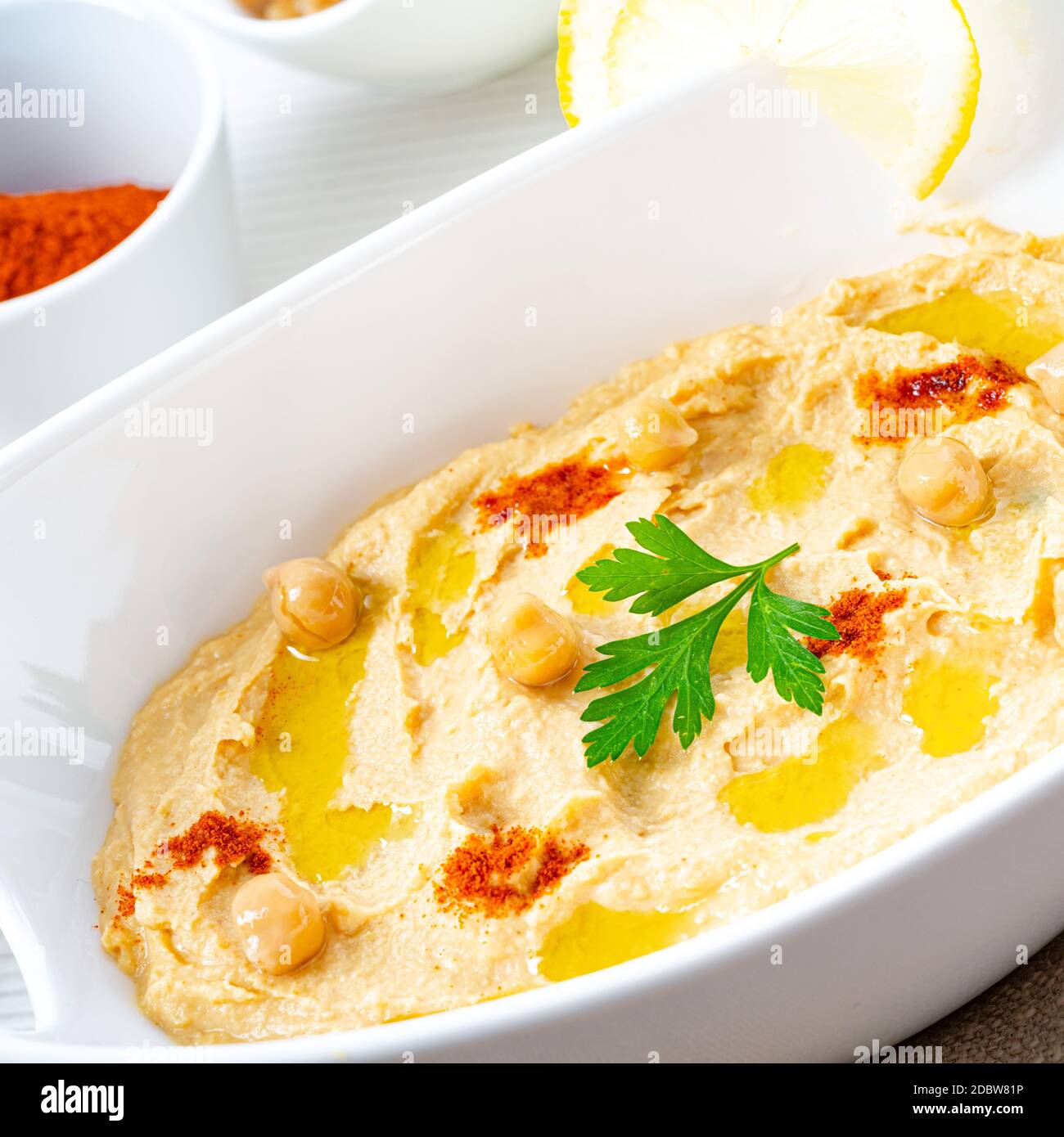 hummus paste with lemon and chilli on white background Stock Photo - Alamy