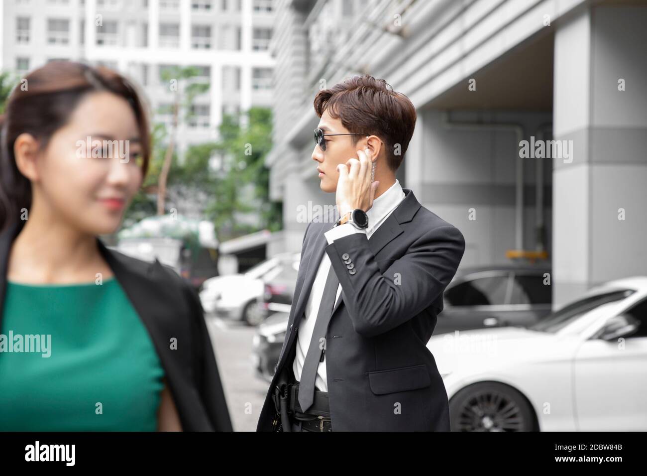 Asian male and female two security guards 001 Stock Photo - Alamy