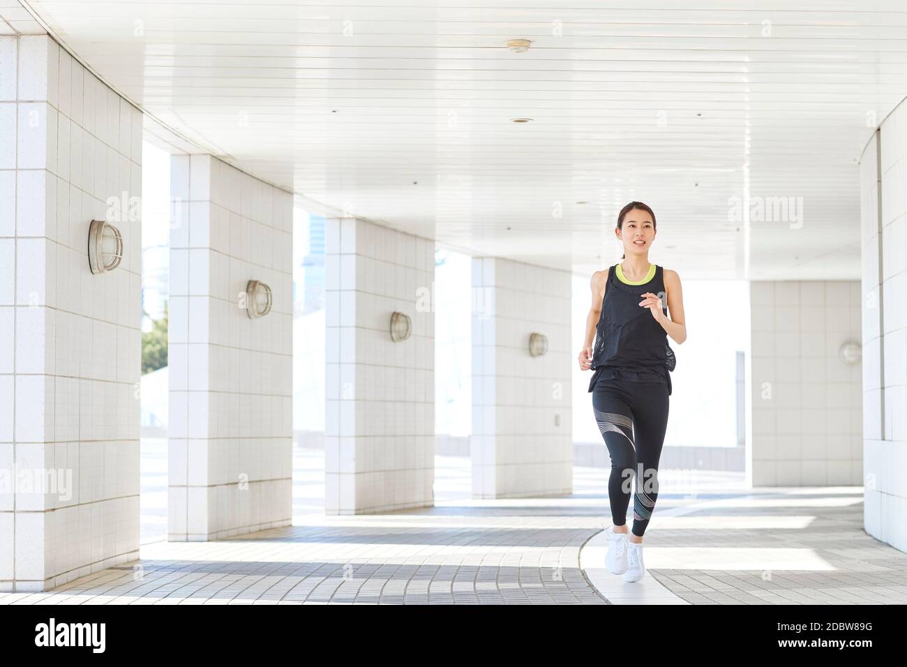 Young Japanese Woman Running Downtown Tokyo, Japan Stock Photo - Alamy