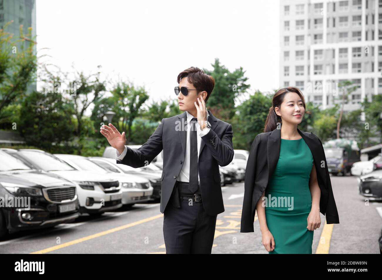 Asian male and female two security guards 003 Stock Photo - Alamy