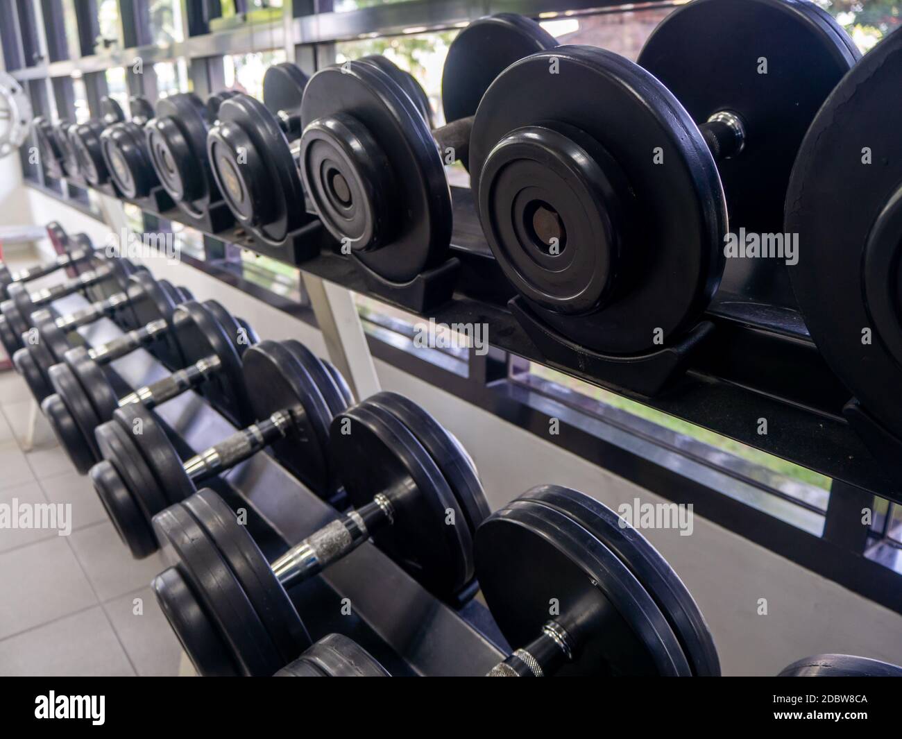 dumbbell set. Close up many metal dumbbells on rack in sport fitness ...