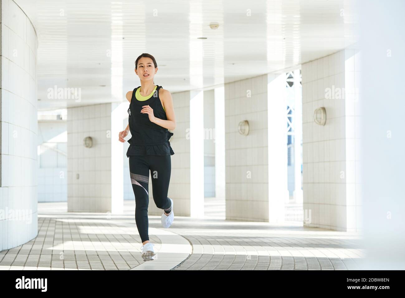 Young Japanese Woman Running Downtown Tokyo, Japan Stock Photo - Alamy