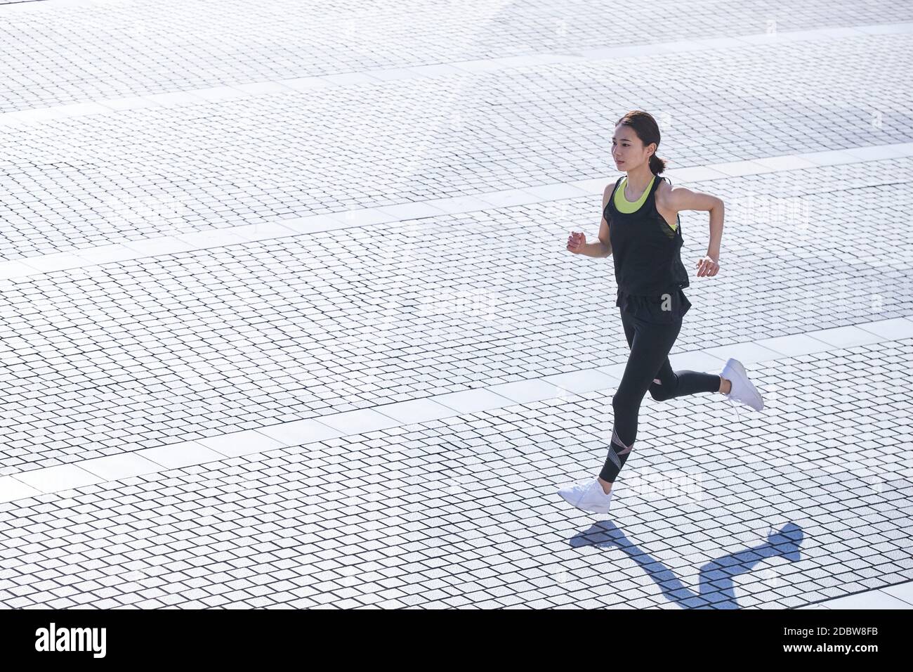 Young Japanese Woman Running Downtown Tokyo, Japan Stock Photo - Alamy