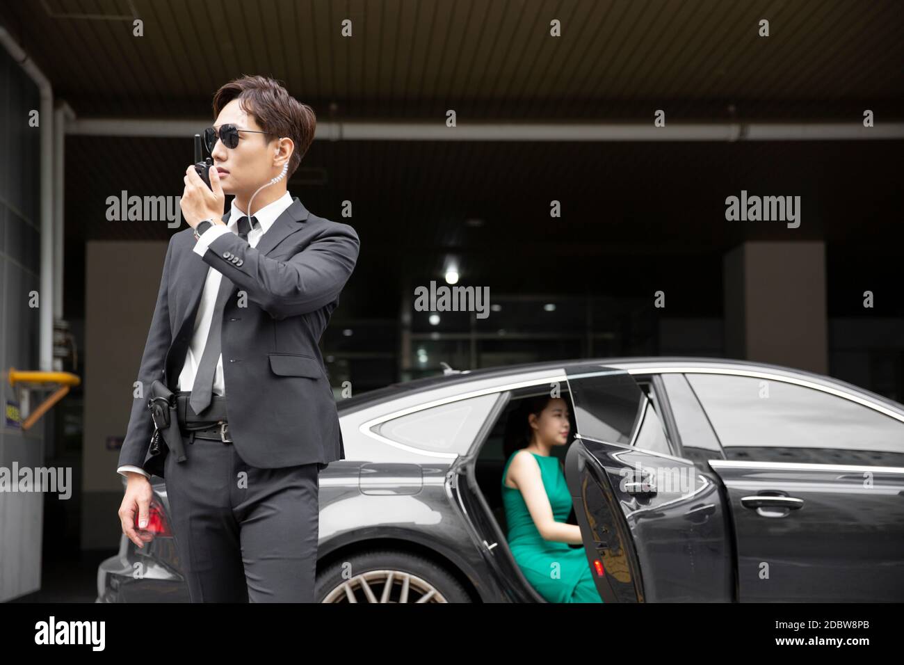 Asian male and female two security guards 009 Stock Photo - Alamy