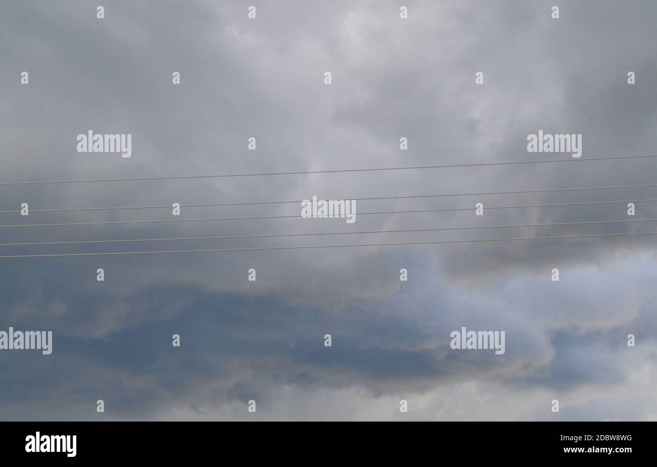Electricity transmission power lines, high voltage lines. Storm clouds ...