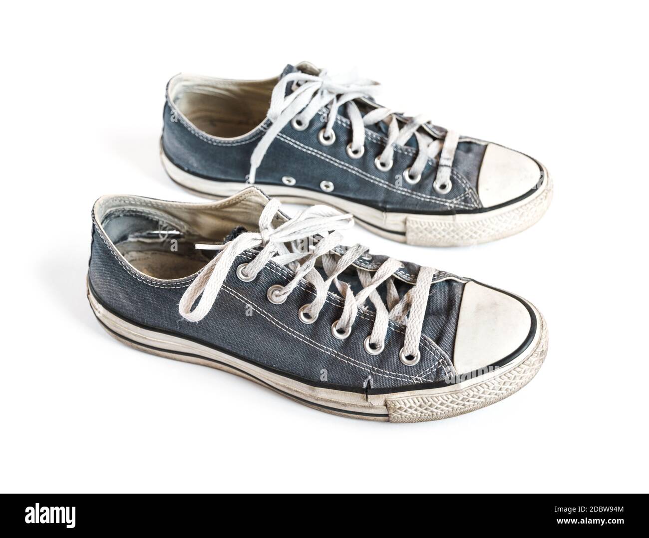 Old blue generic sneakers isolated on white background Stock Photo - Alamy