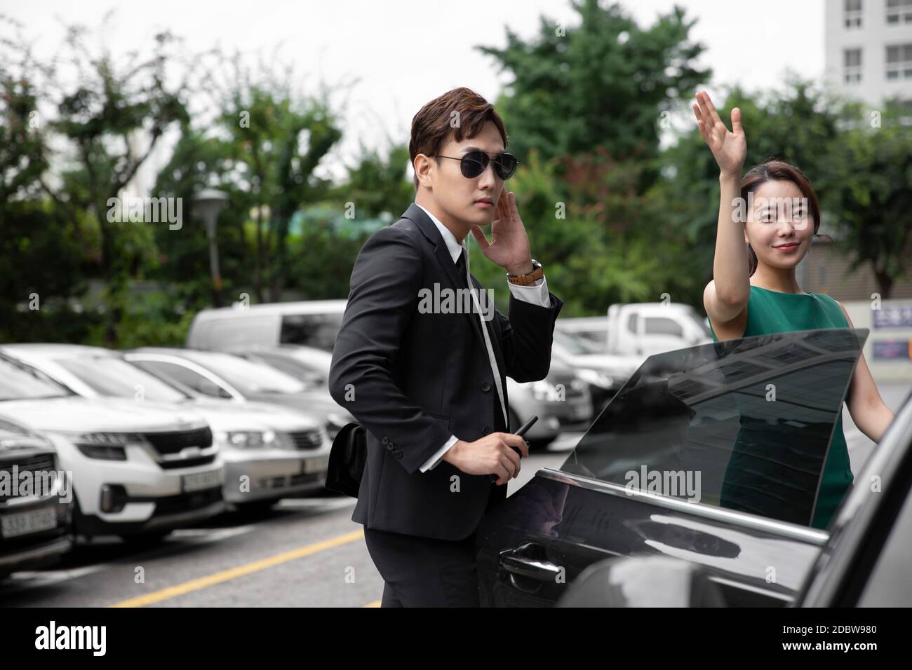 Asian male and female two security guards 013 Stock Photo - Alamy