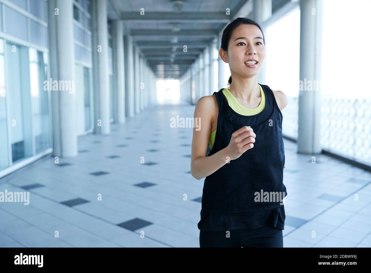 Young Japanese Woman Running Downtown Tokyo, Japan Stock Photo - Alamy