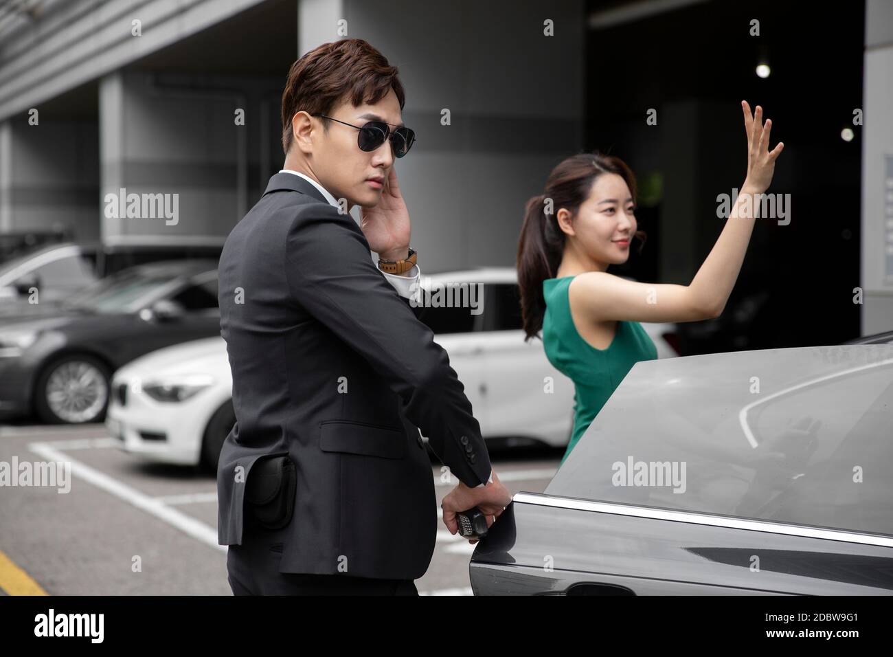 Asian male and female two security guards 014 Stock Photo - Alamy