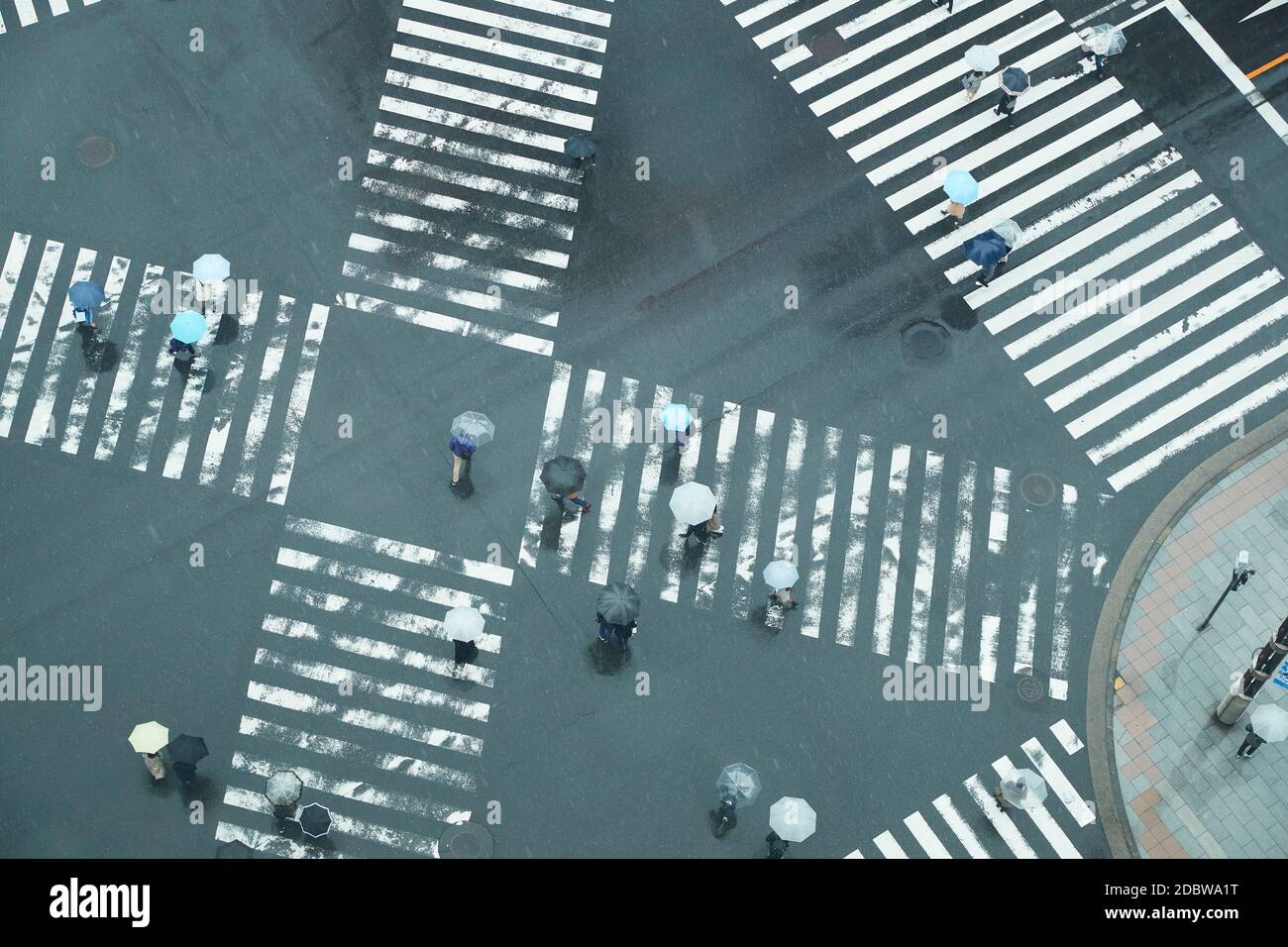 People Crossing A Crossroad On A Rainy Day In Tokyo, Japan Stock Photo ...