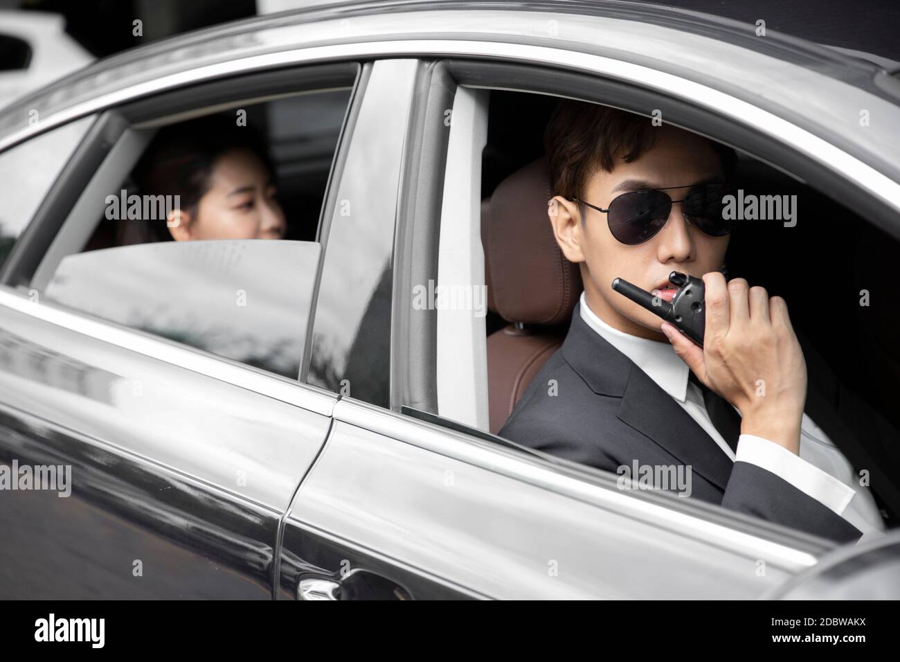 Asian male and female two security guards 020 Stock Photo - Alamy