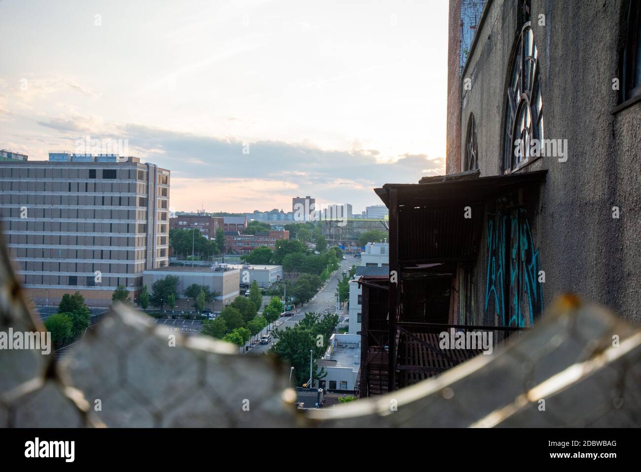 Looking Out a Broken Window in a Tall Abandoned Building at a Busy City ...
