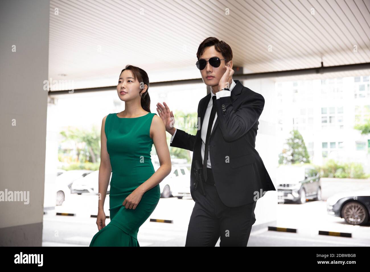 Asian male and female two security guards 028 Stock Photo - Alamy