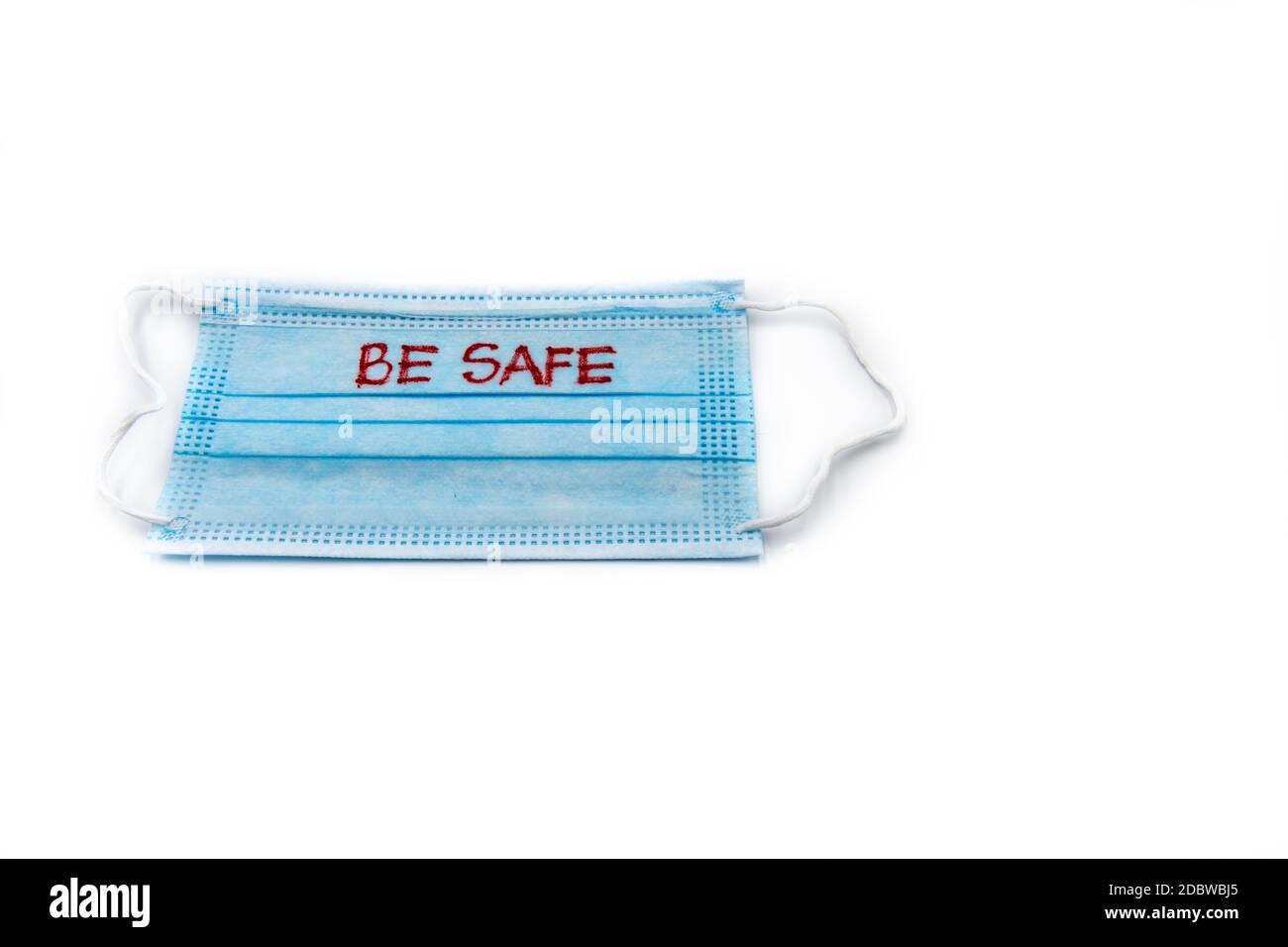 Single use medical face mask with handwritten message Be Safe isolated ...