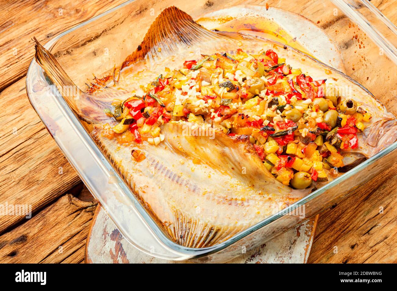 Flat-fish with vegetables on rustic background.Fried fish with ...