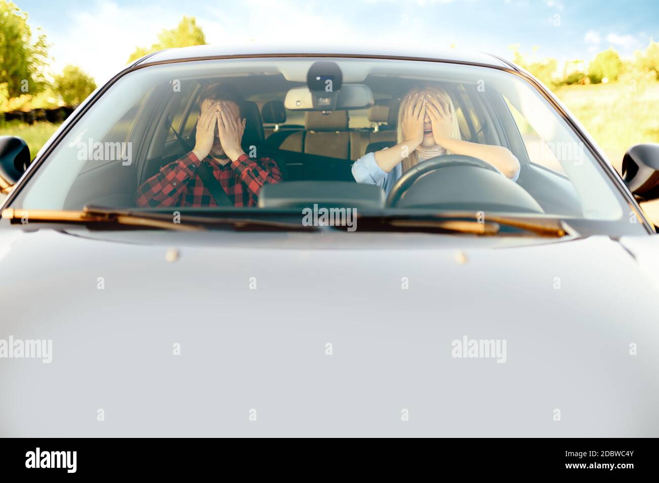 Scared woman and instructor in car, front view, driving school. Man ...