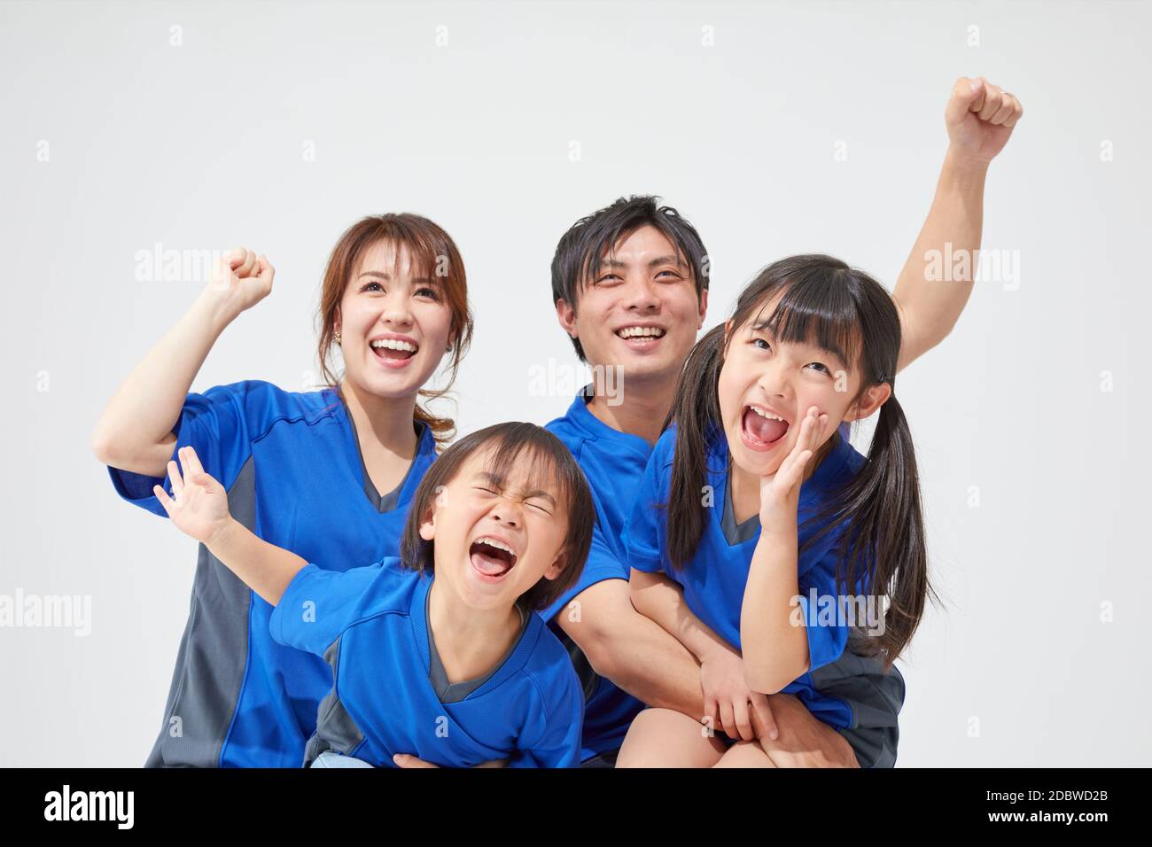 Family Watching A Game And Cheering Stock Photo - Alamy