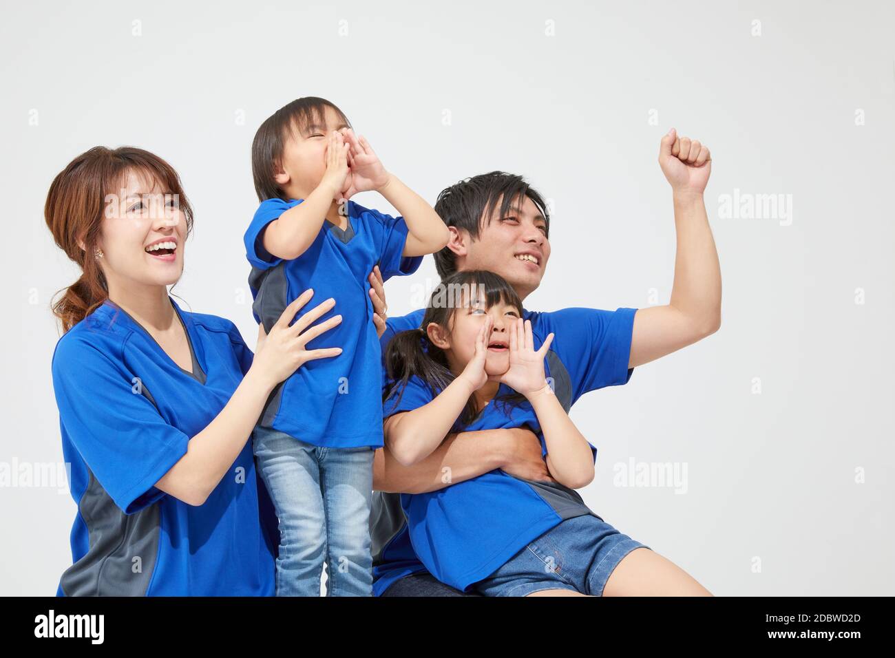 Family Watching A Game And Cheering Stock Photo - Alamy